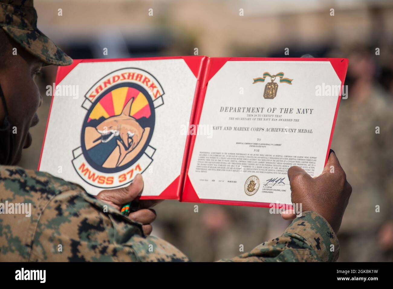 A certificate for a Navy and Marine Corps Achievement Medal is read ...