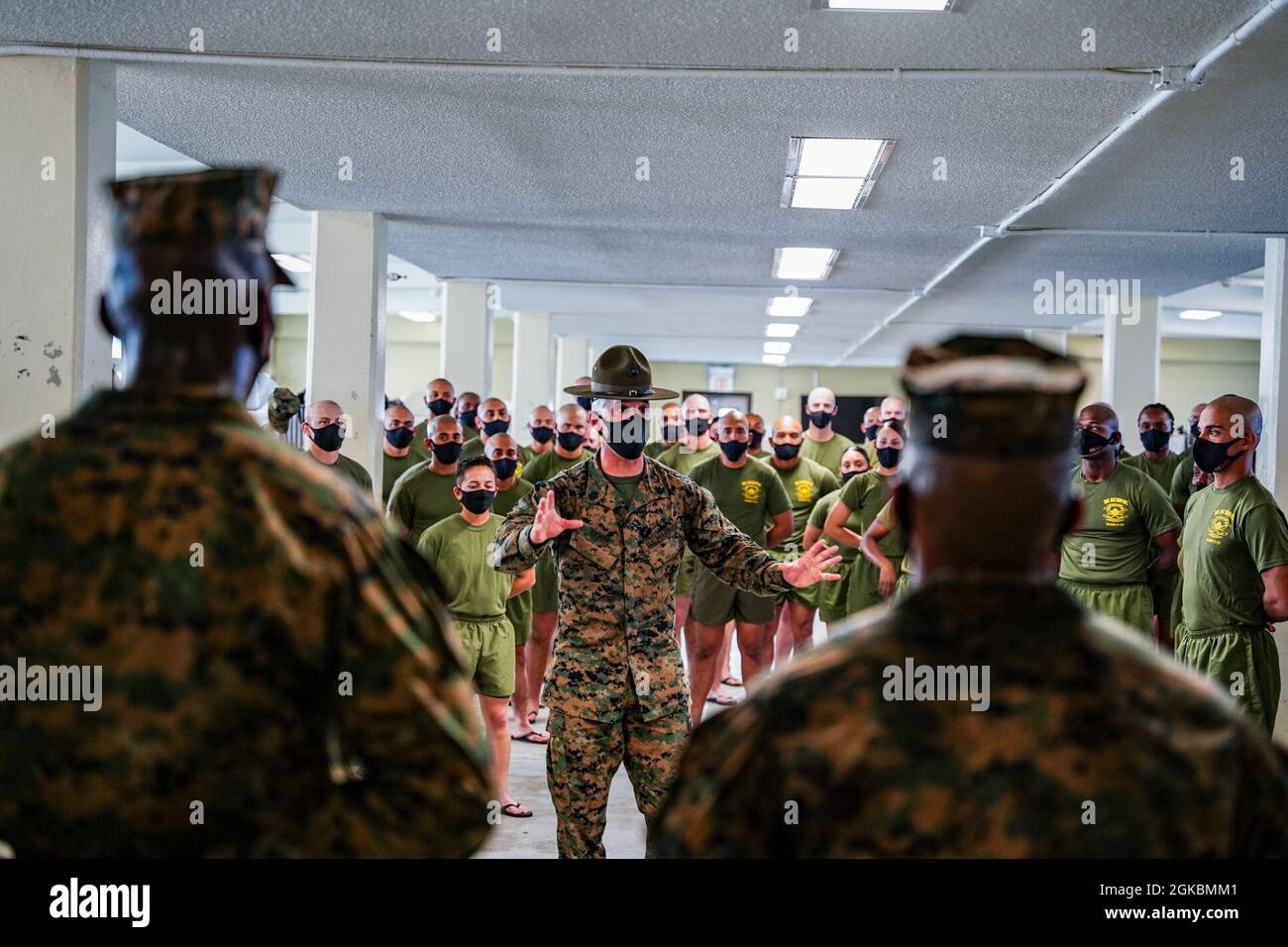 An instructor from Drill Instructor School teaches students squad bay ...