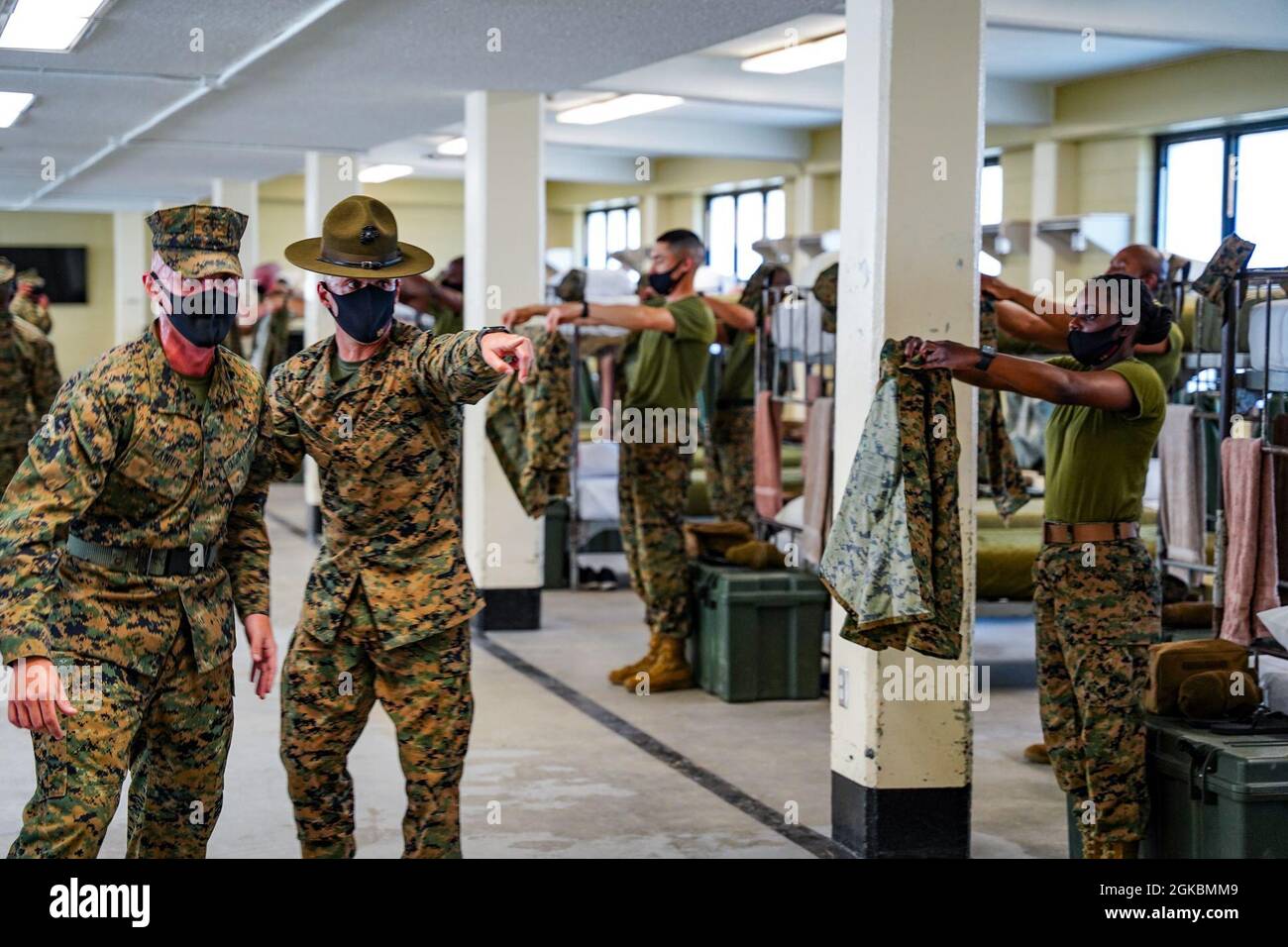 An instructor from Drill Instructor School teaches students squad bay ...