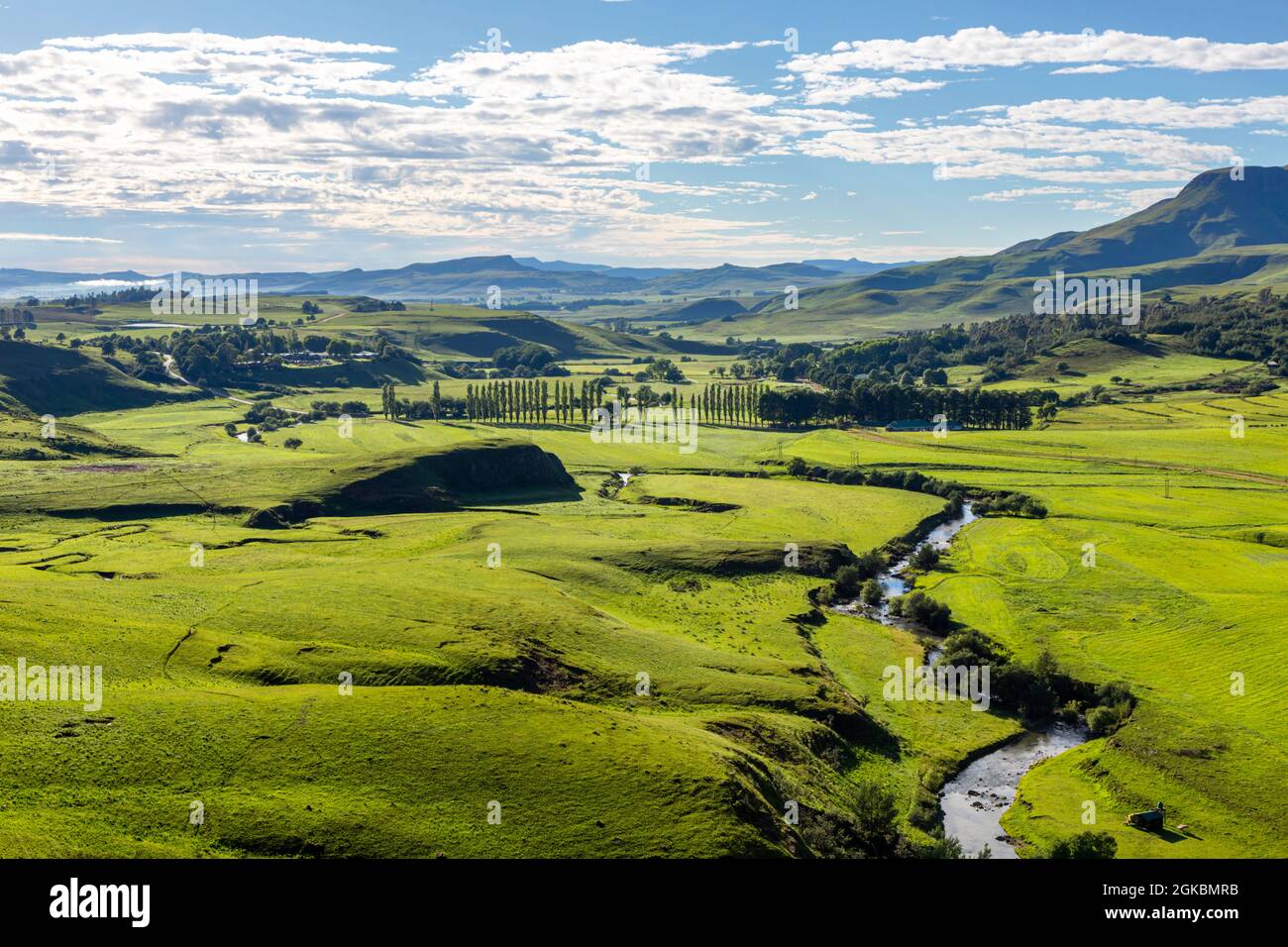 Mountain stream snake through green pastures in the valley below Stock ...