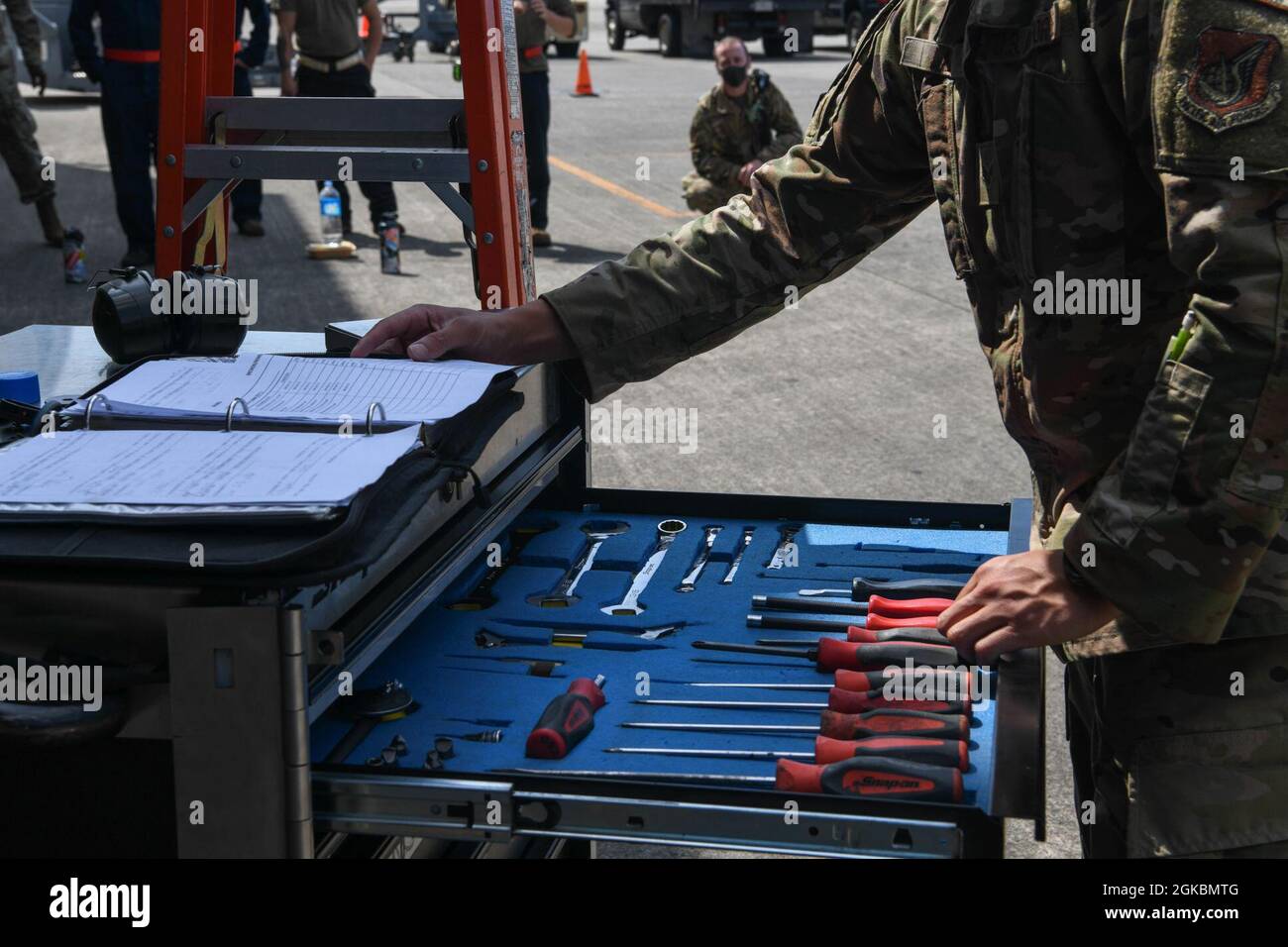 A U.S. Air Force Airman checks that all tools are accounted for during ...