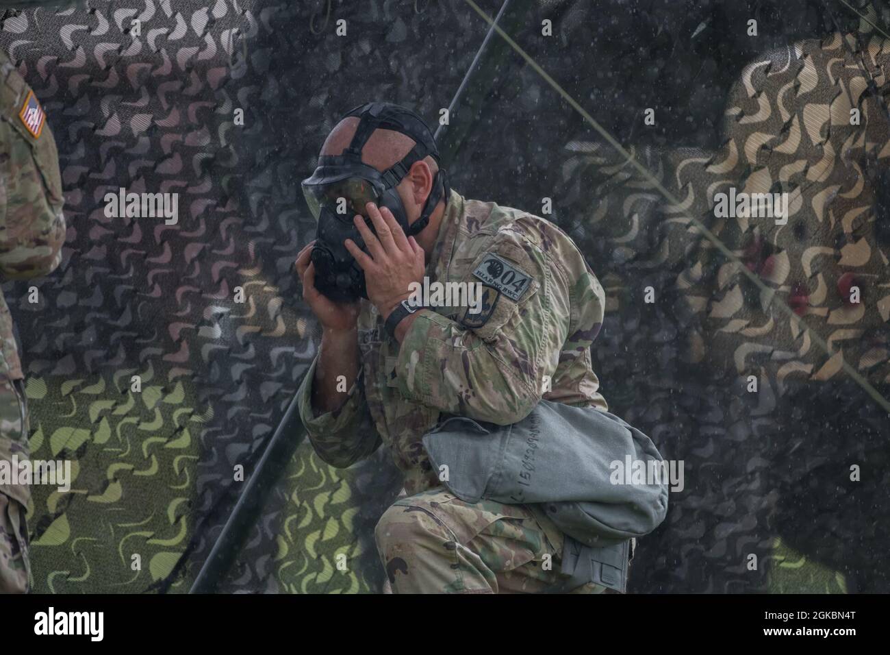 Sgt. Shaun K. Gomes dawns his M50 gas mask as a warrior task during the ...