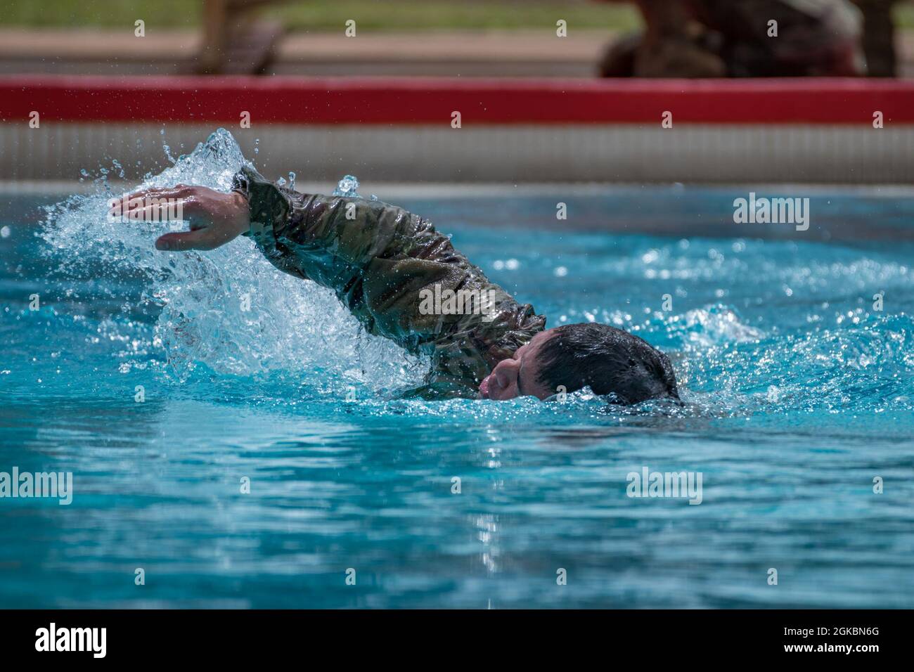 A competitor performs the 100-meter swimming challenge in the Hawaii ...