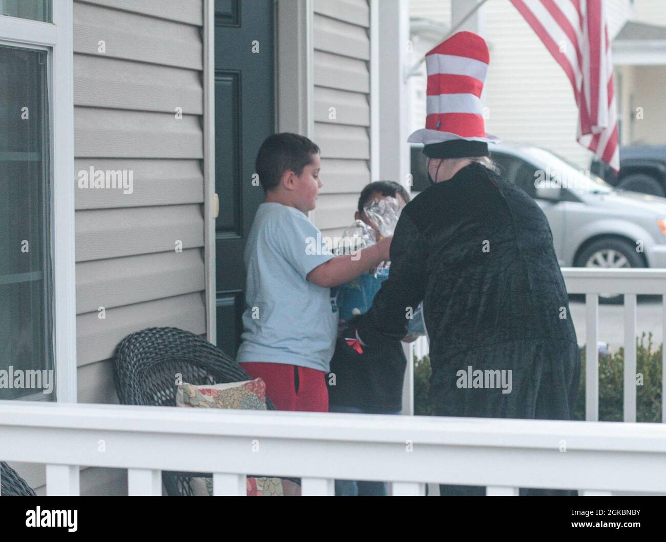 Braydon, left, and Hunter Bryant, accept a basket of books from the Cat ...