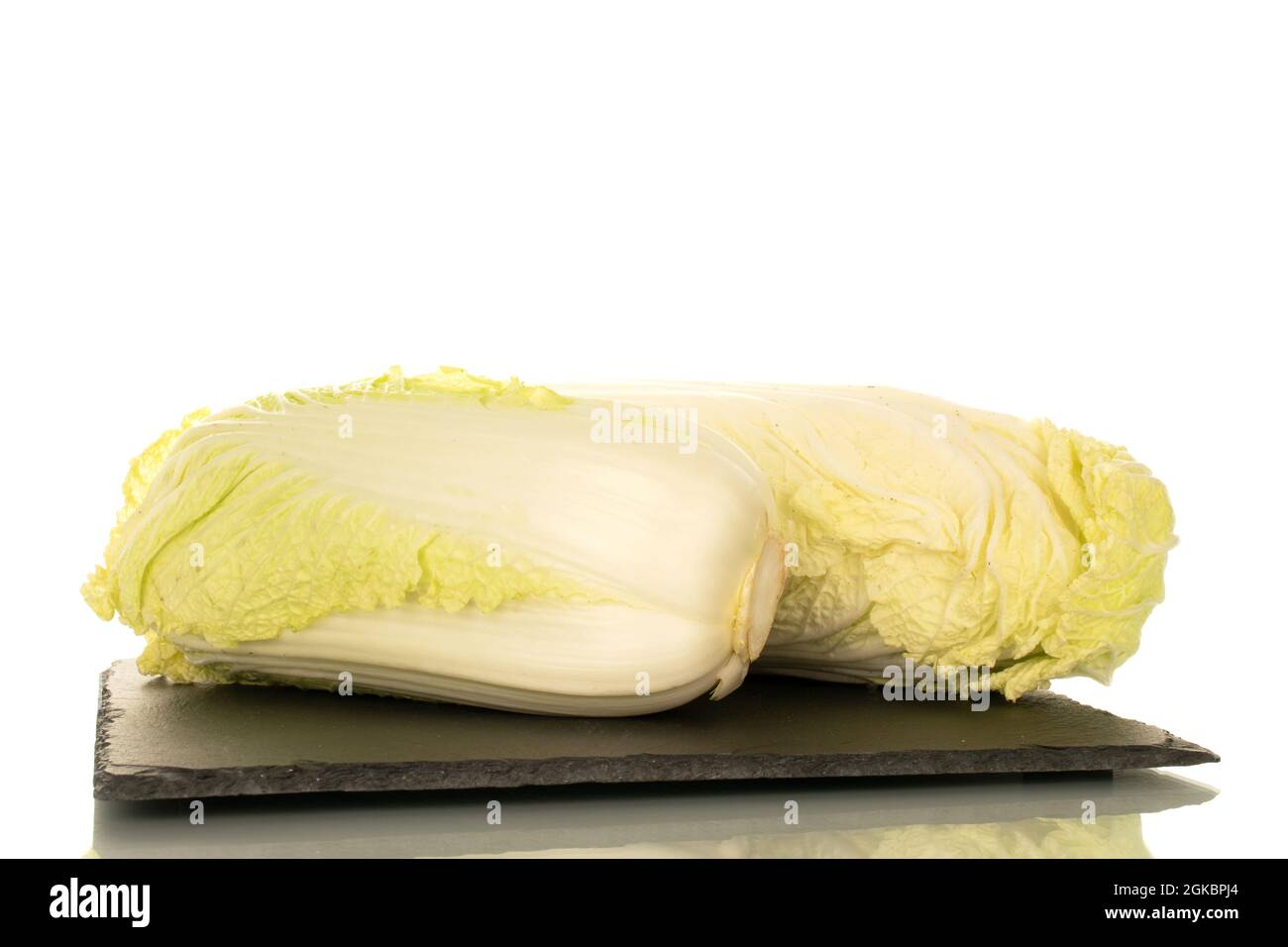 Two organic Chinese cabbage on a slate stone, close-up, isolated on ...