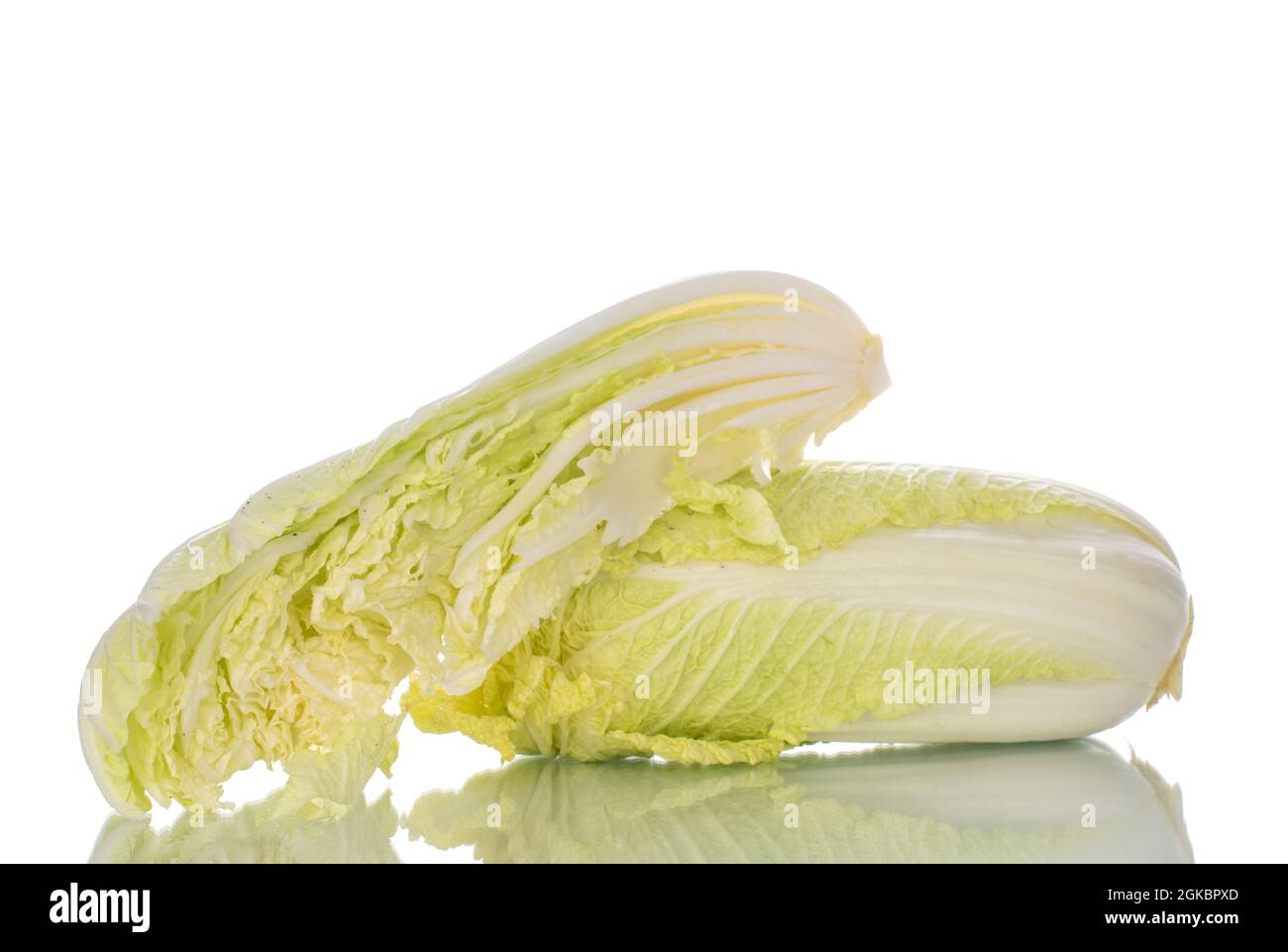 One whole and one half ripe fresh Chinese cabbage, close-up, isolated ...
