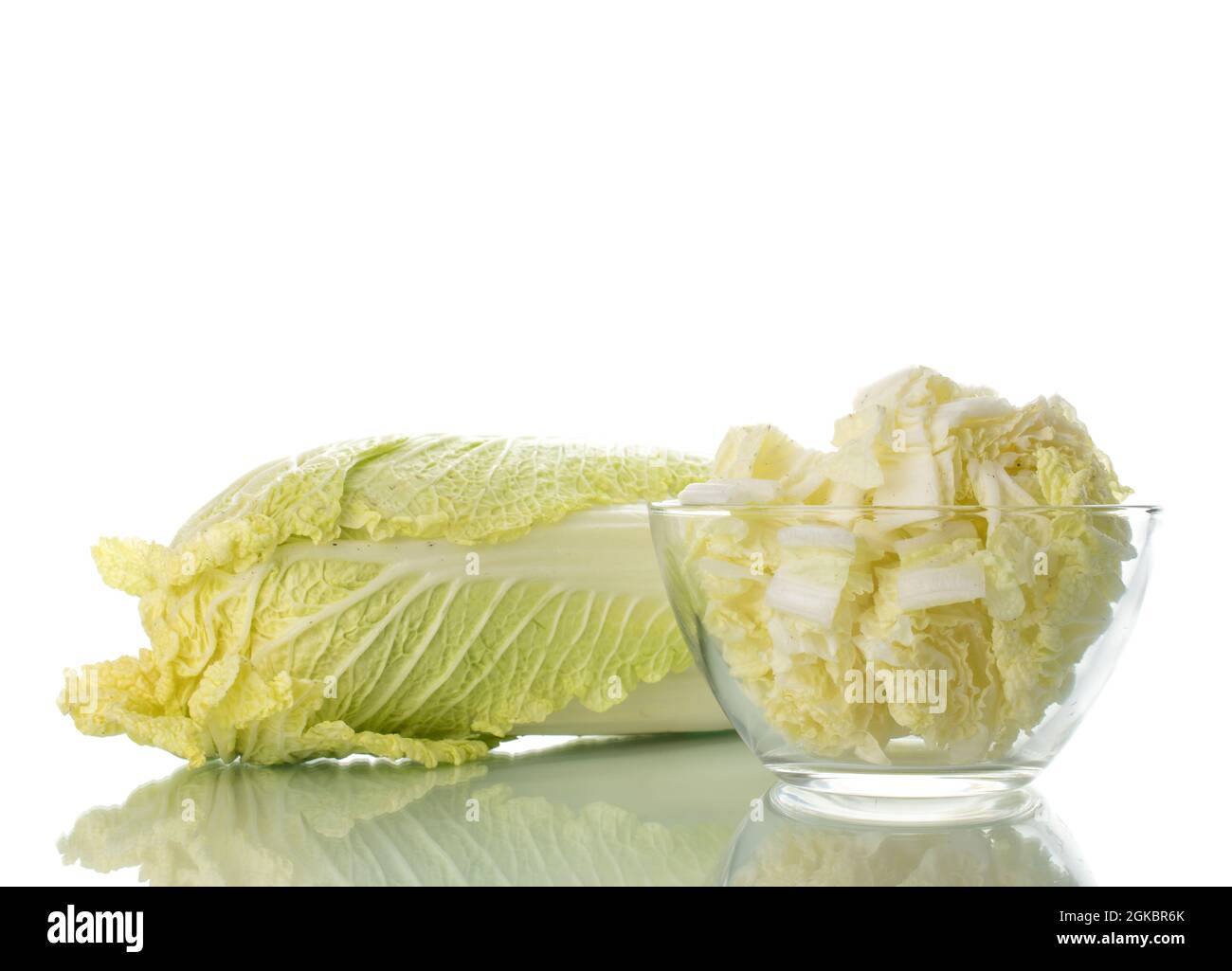 One ripe fresh Chinese cabbage and shredded cabbage in a glass bowl ...