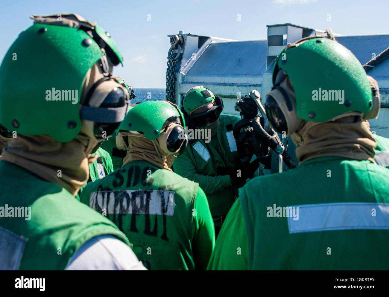 210306-N-LU761-1219 PACIFIC OCEAN (Mar. 6, 2021) Sailors receive ...