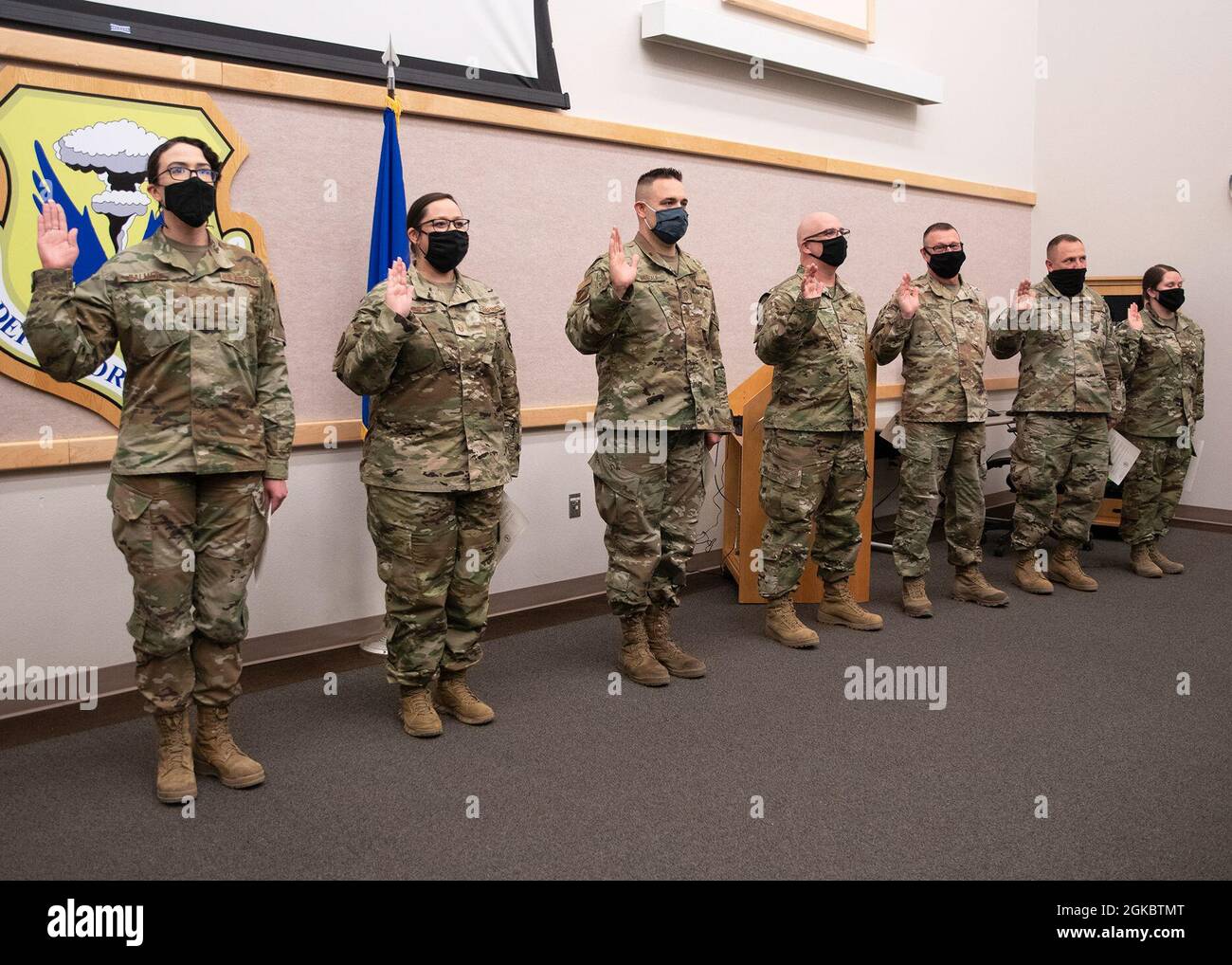 Air National Guard members with the 131st Bomb Wing raise their right ...
