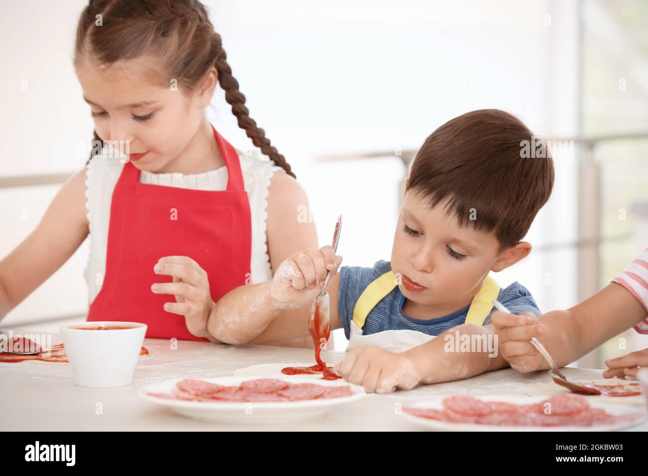 Cute children in kitchen during cooking classes Stock Photo - Alamy