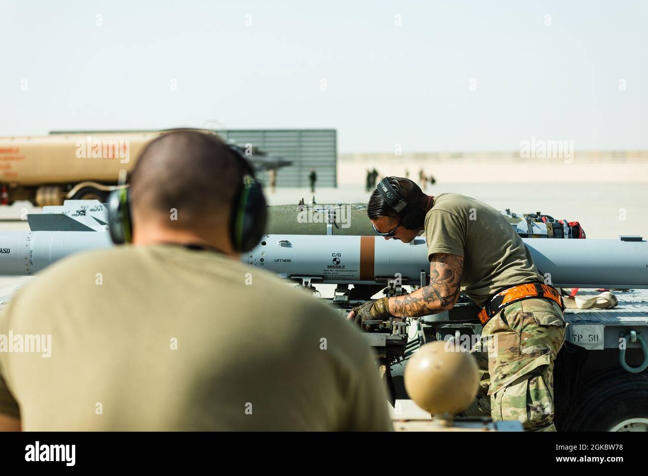 Weapons Airmen with the 332nd Air Expeditionary Wing prepare to load ...