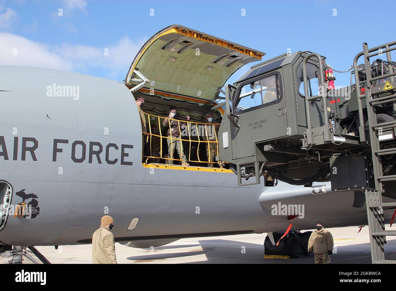 Airman 1st Class Devin Kavanaugh directs a cargo load in to position ...