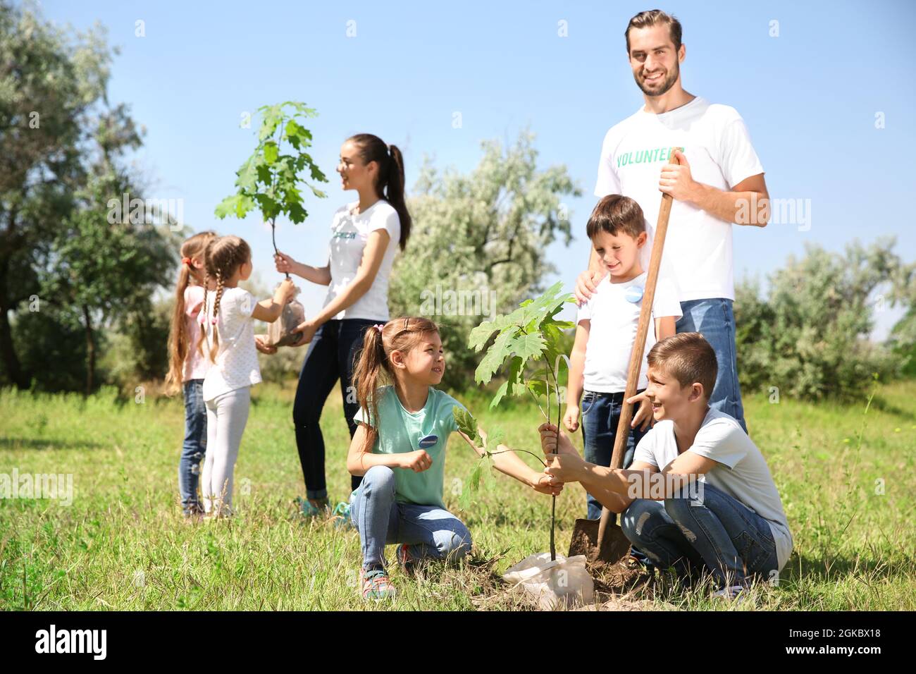 Children planting tree in park hi-res stock photography and images - Alamy