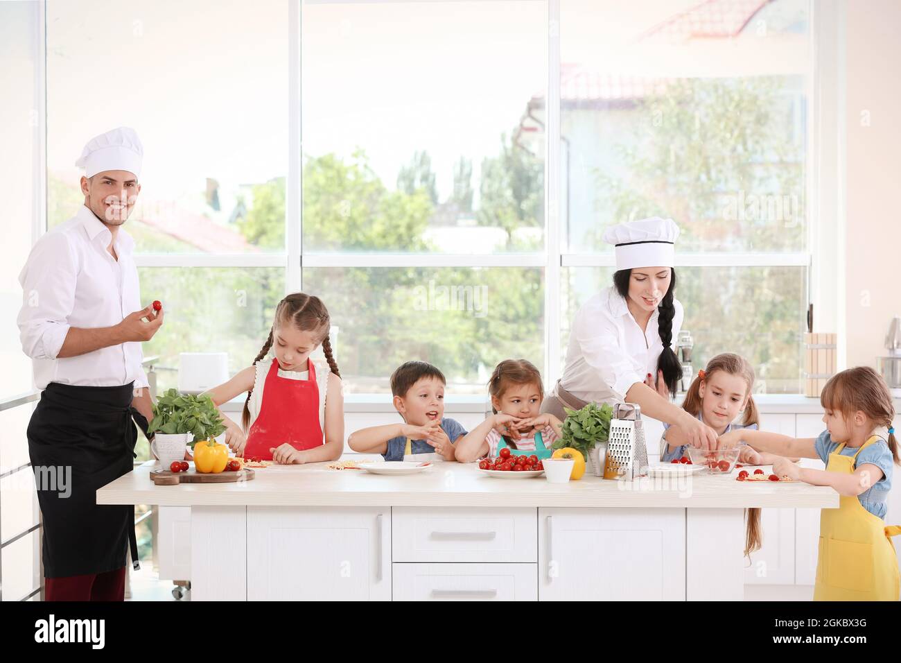 Group of children table cooking chef hi-res stock photography and ...
