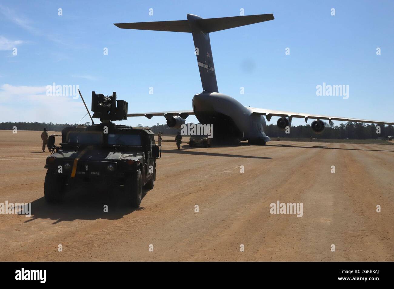 Humvee drives away from Air Force transport plane at Joint Readiness ...