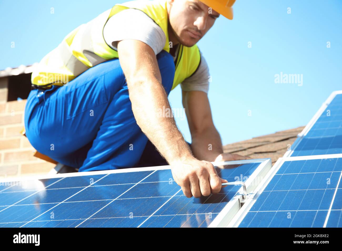 Worker installing solar panels outdoors Stock Photo - Alamy