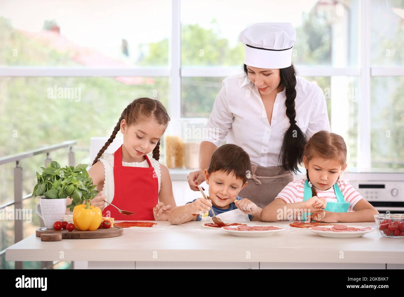 Group of children and teacher in kitchen during cooking classes Stock ...