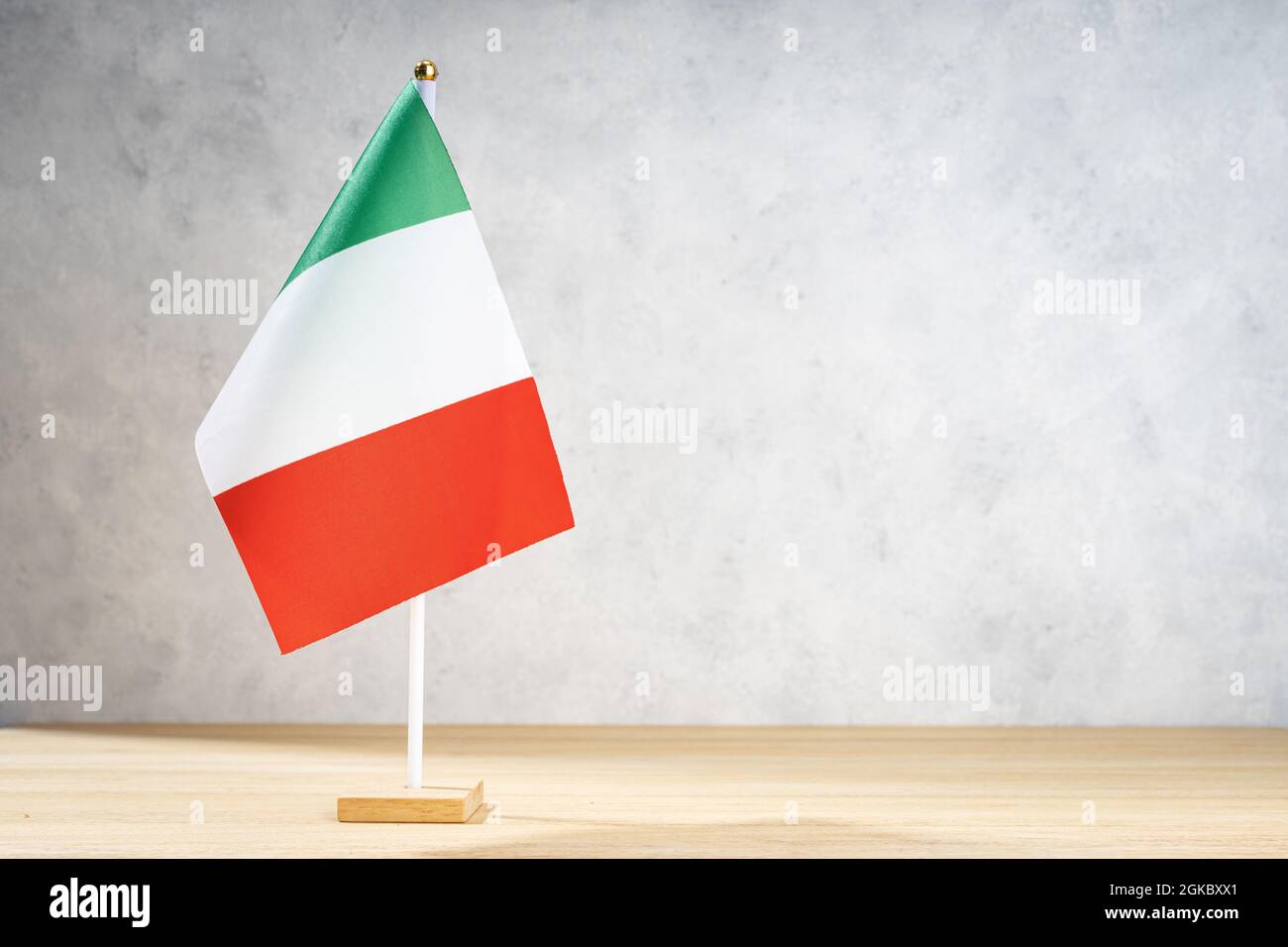 Italy table flag on white textured wall. Copy space for text, designs ...