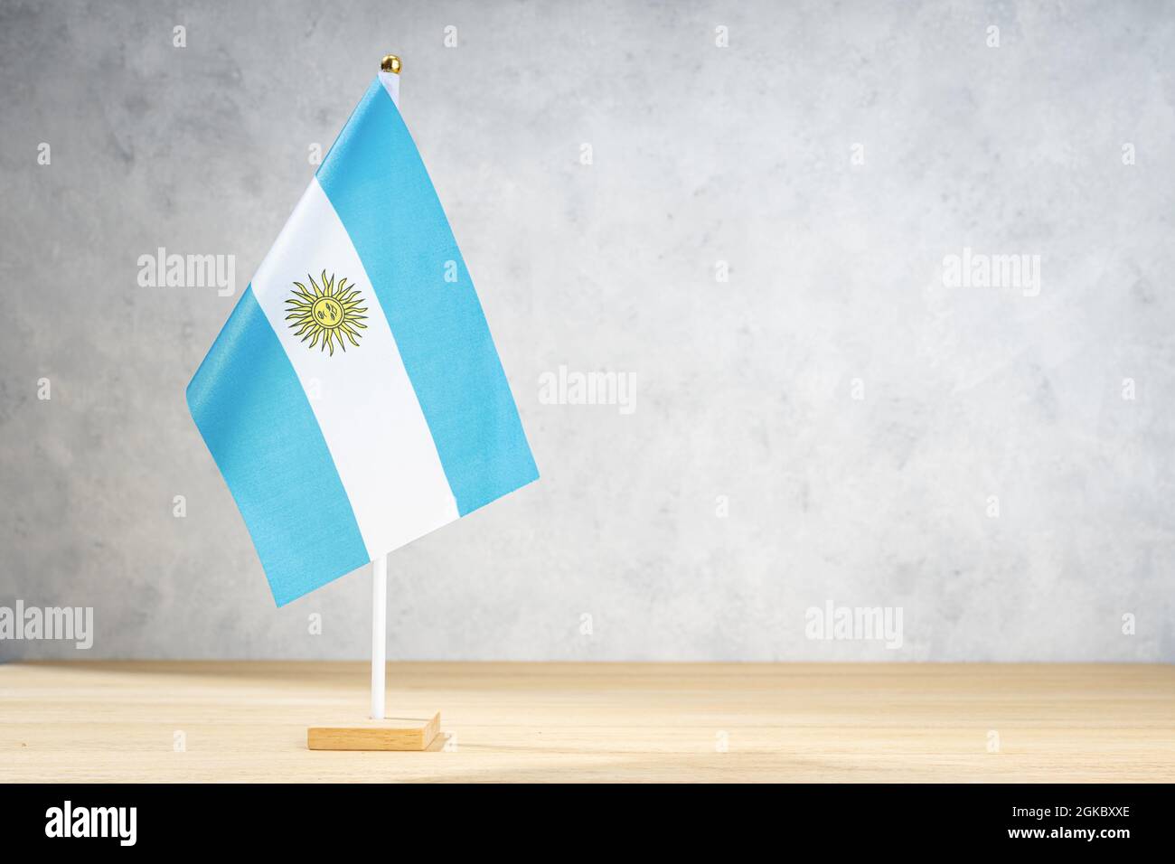 Argentina table flag on white textured wall. Copy space for text ...