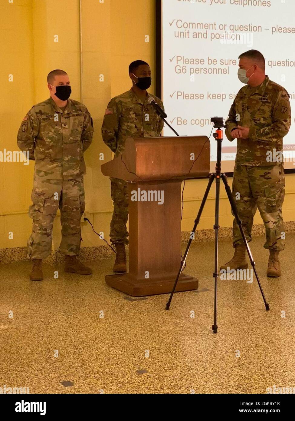 Maj. Gen. Ling, 79th TSC, commanding general, presents a coin to both ...