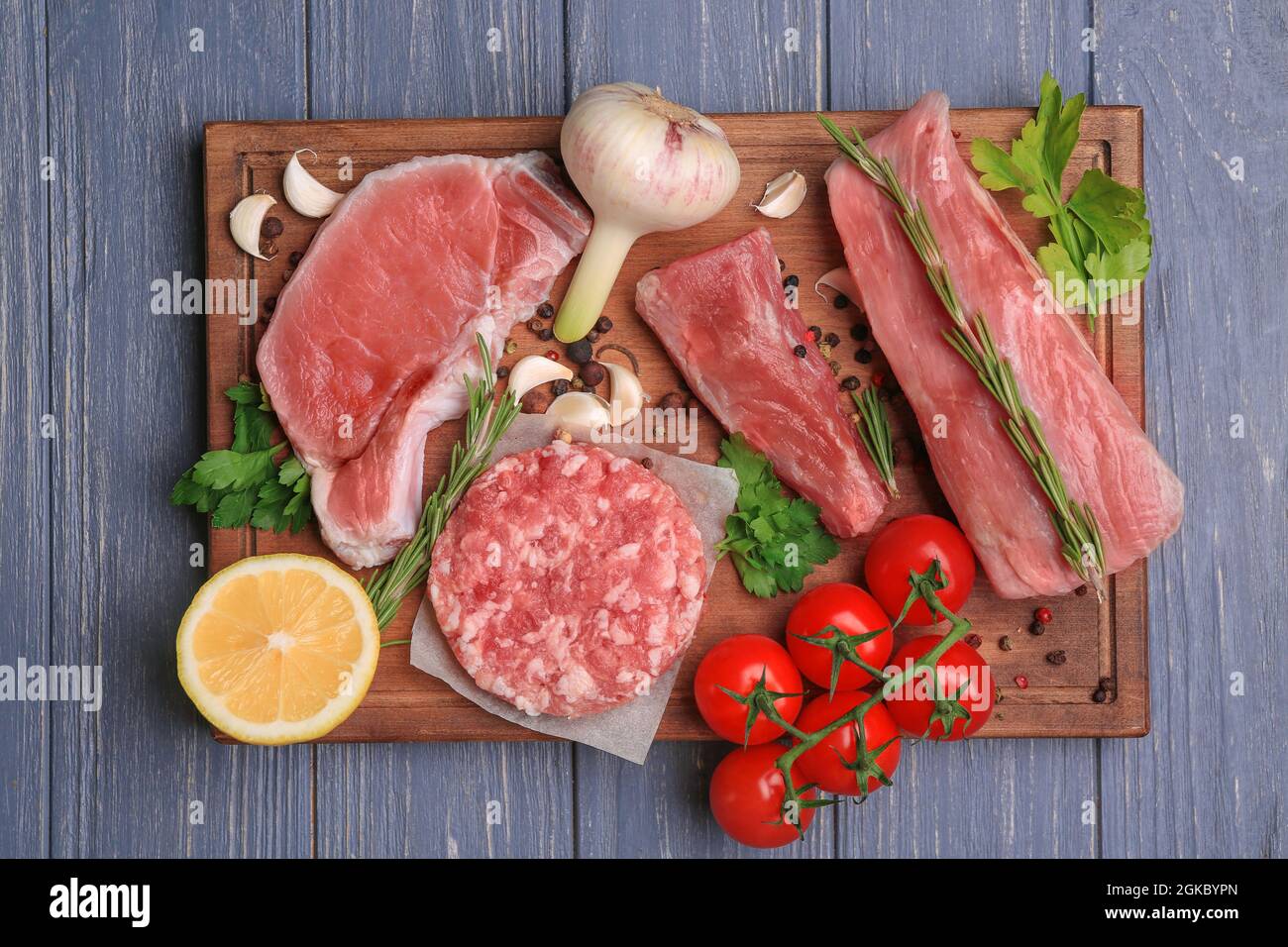 Wooden board with different types of meat on table Stock Photo - Alamy