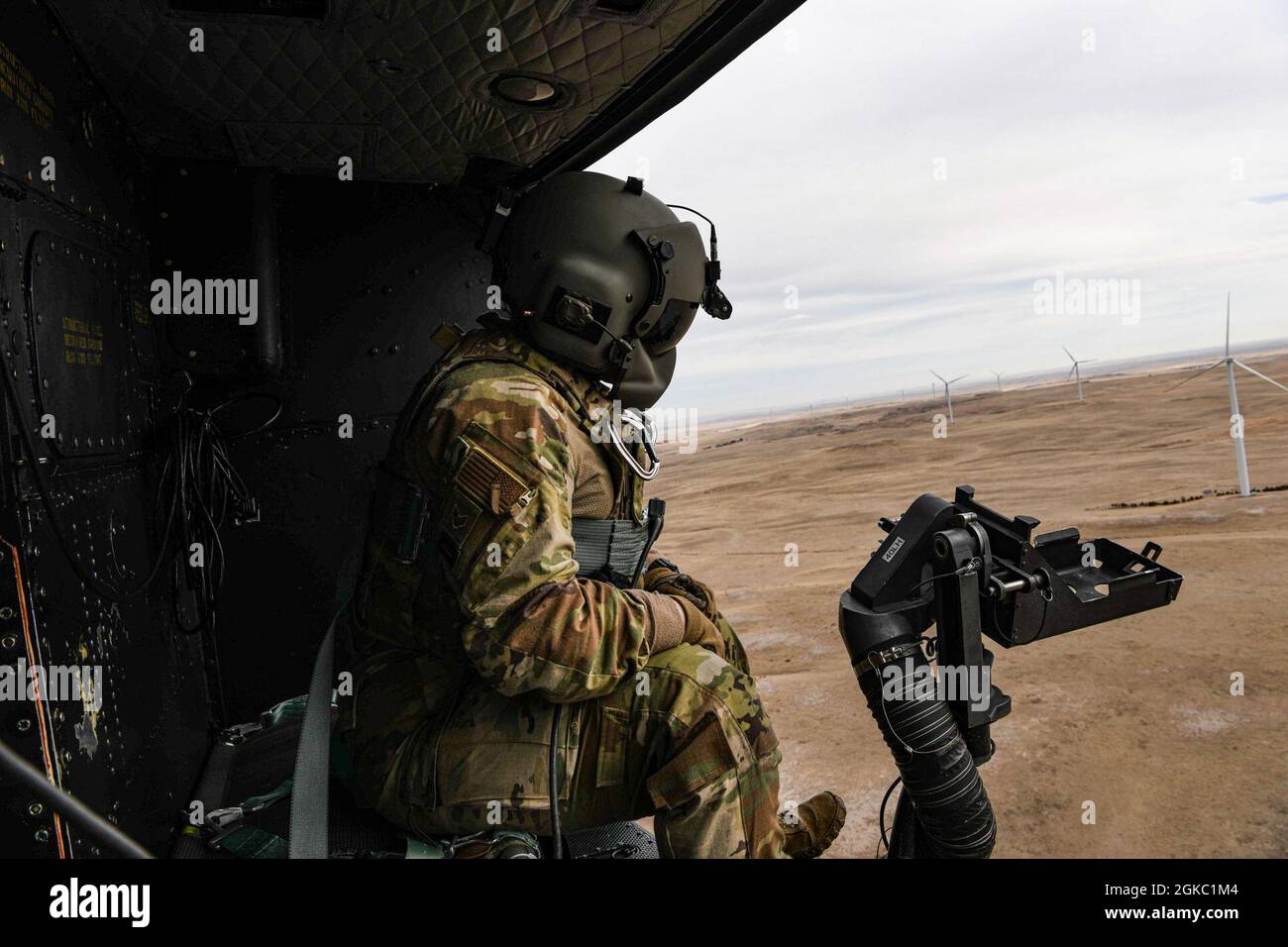 Senior Airman Kayli Conrad, flight engineer and gunner, looks out over ...