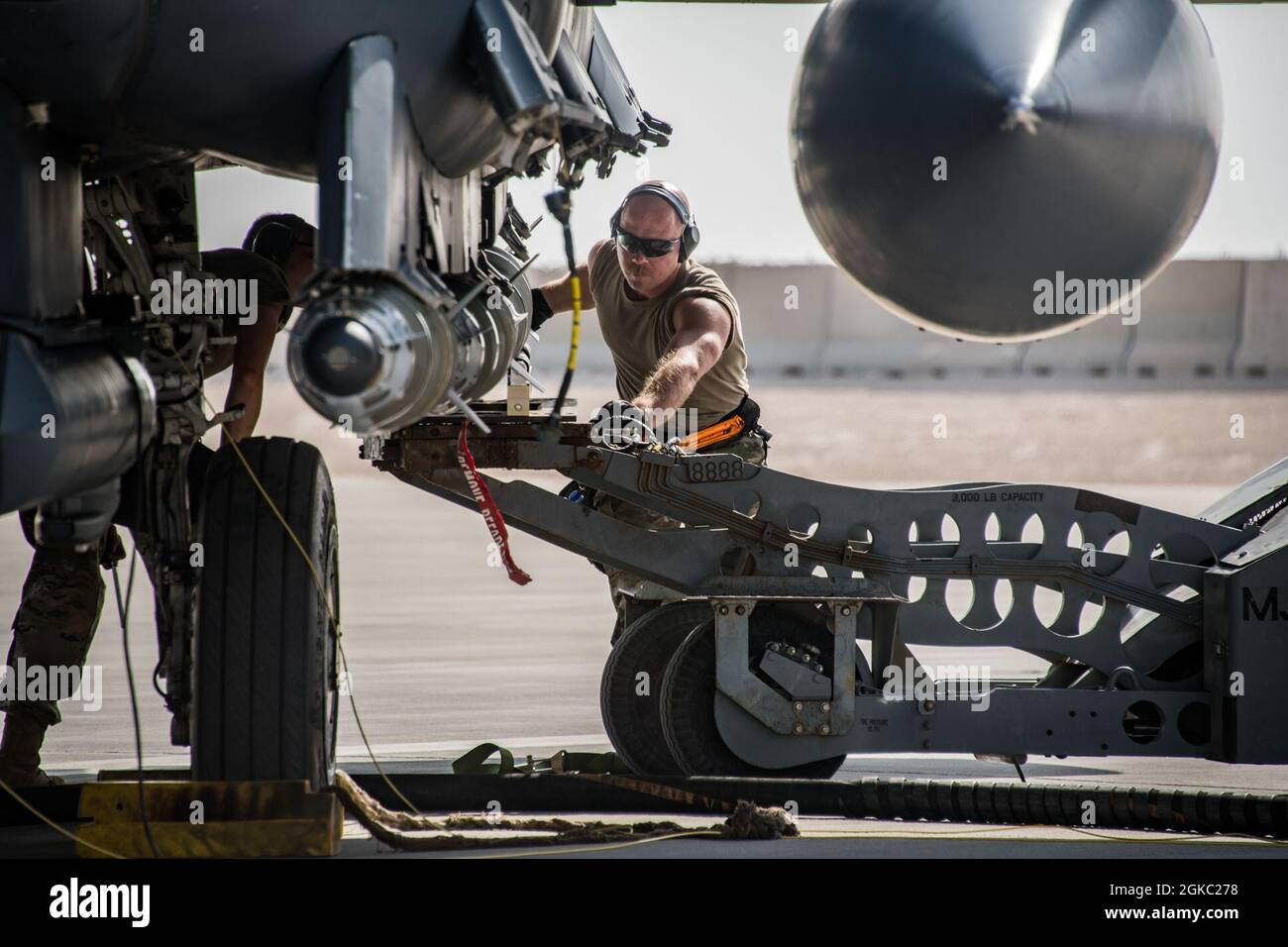 U.S. Airmen with the 379th Expeditionary Maintenance Squadron munitions ...