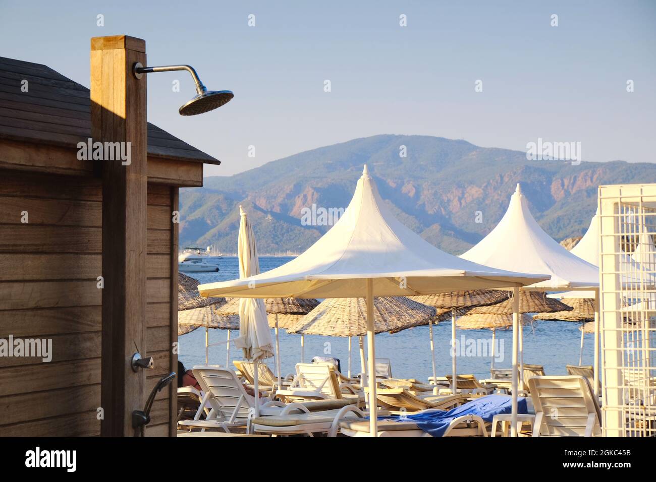 Comfortable sun loungers on sea beach at resort Stock Photo - Alamy