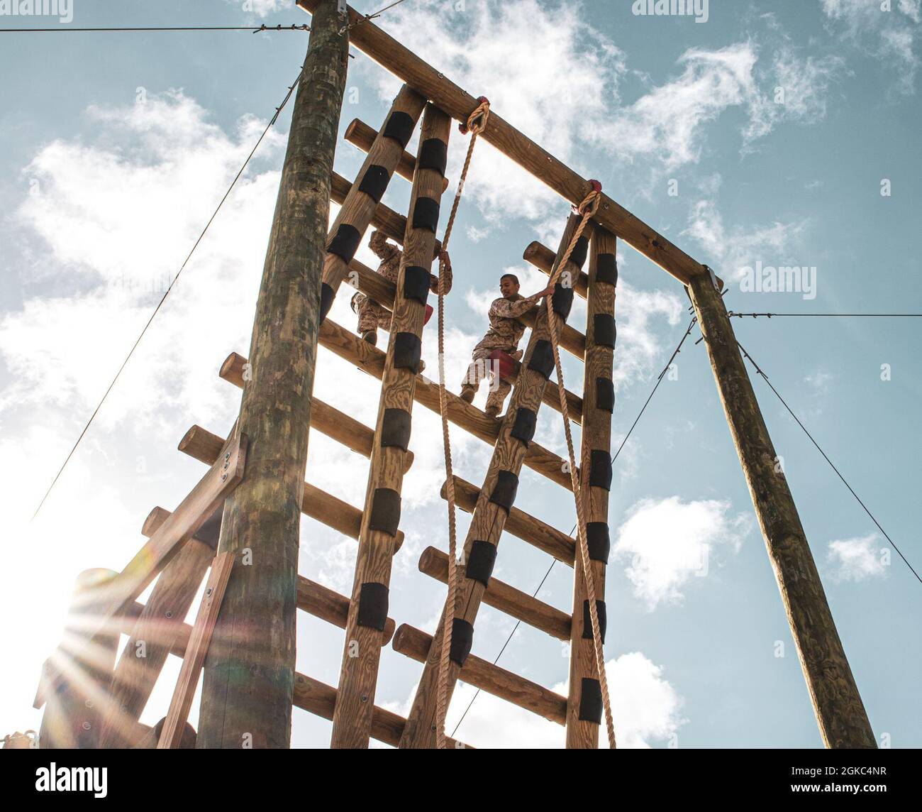 U.S. Marine recruits with Lima Company execute the A-Frame obstacle as ...