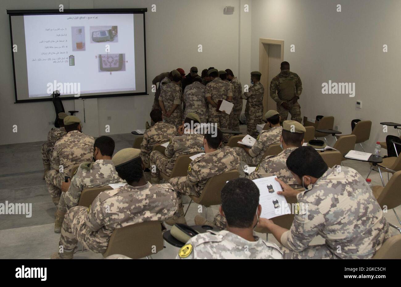 Qatari soldiers listen while U.S. Army Soldiers from 318th Chemical ...