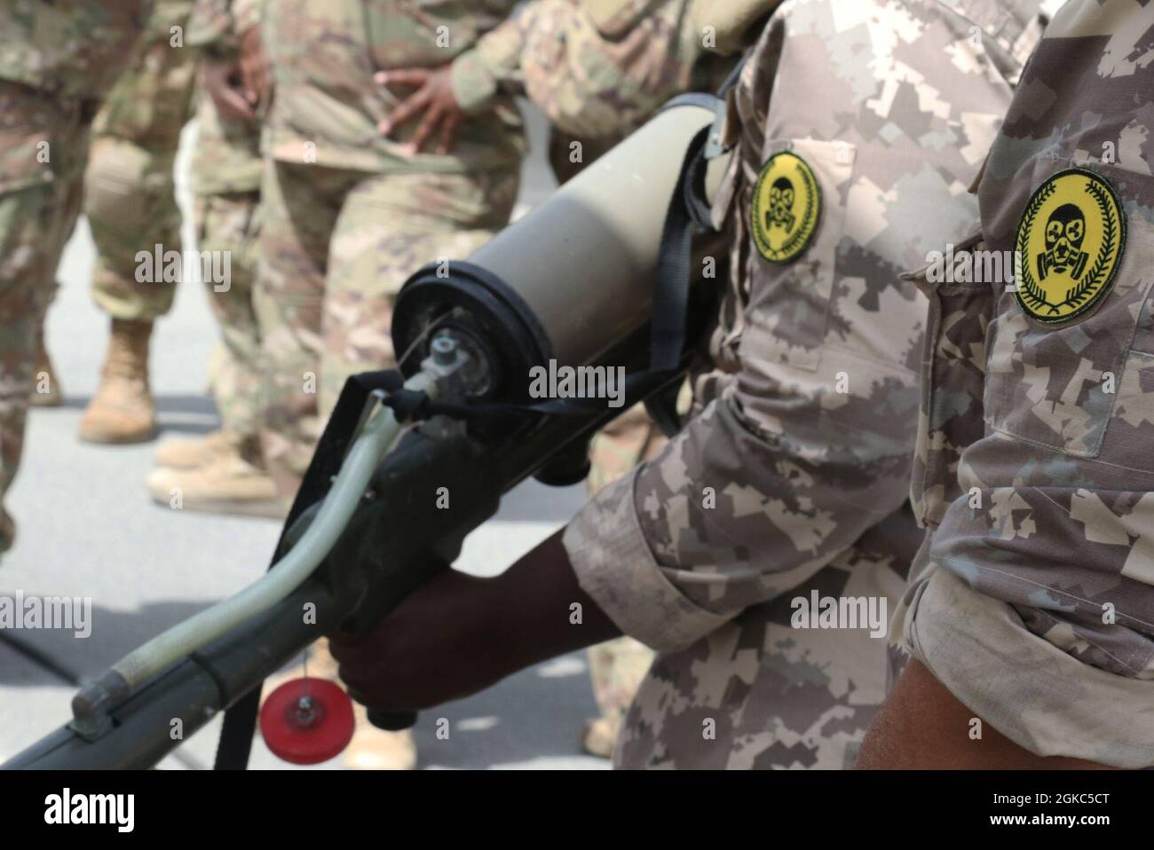 Qatari soldiers set up a sprayer system for their mobile ...