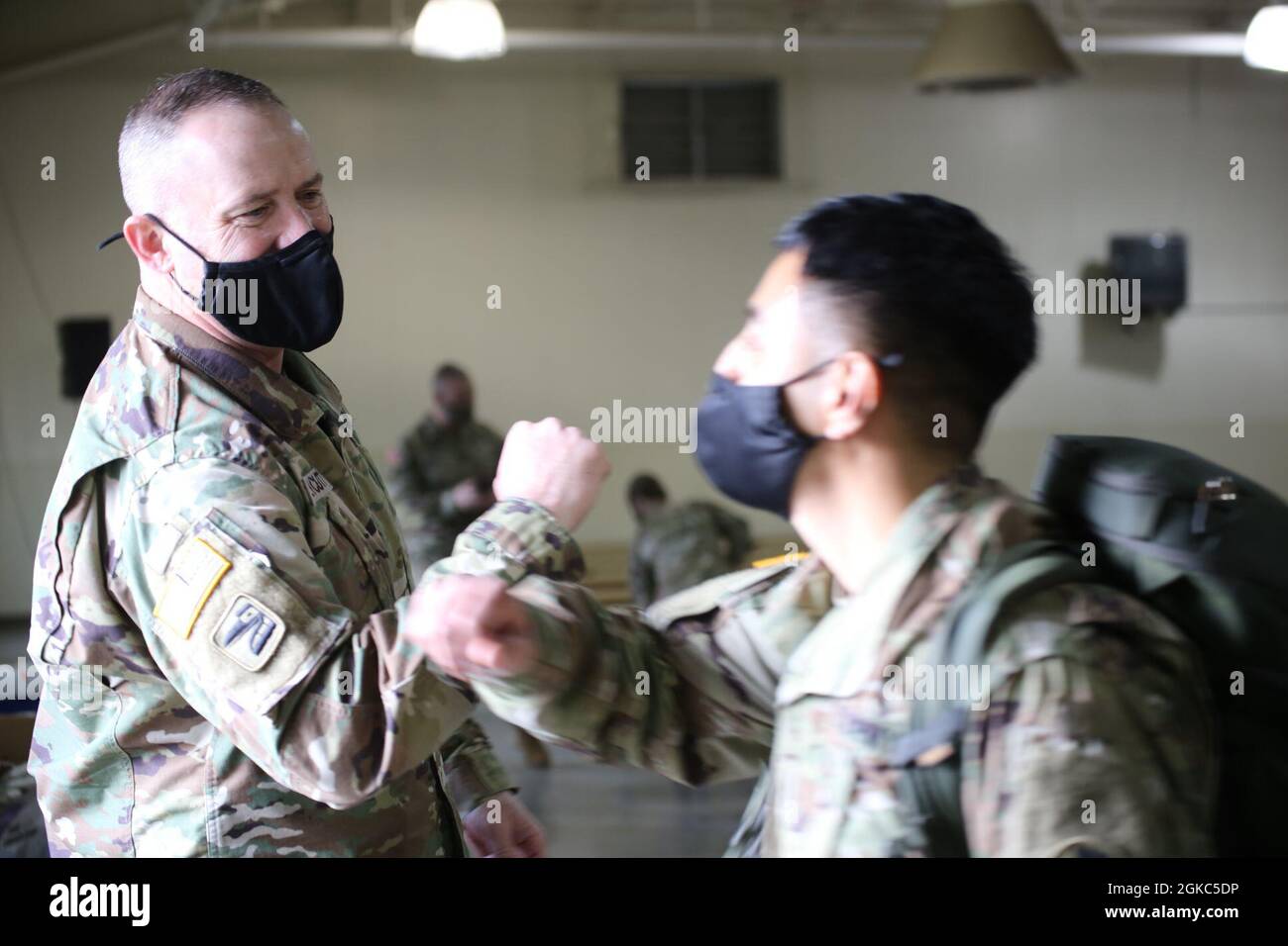 Command Sgt. Maj. Eric Honeycutt bumps elbows with the Soldiers in the ...