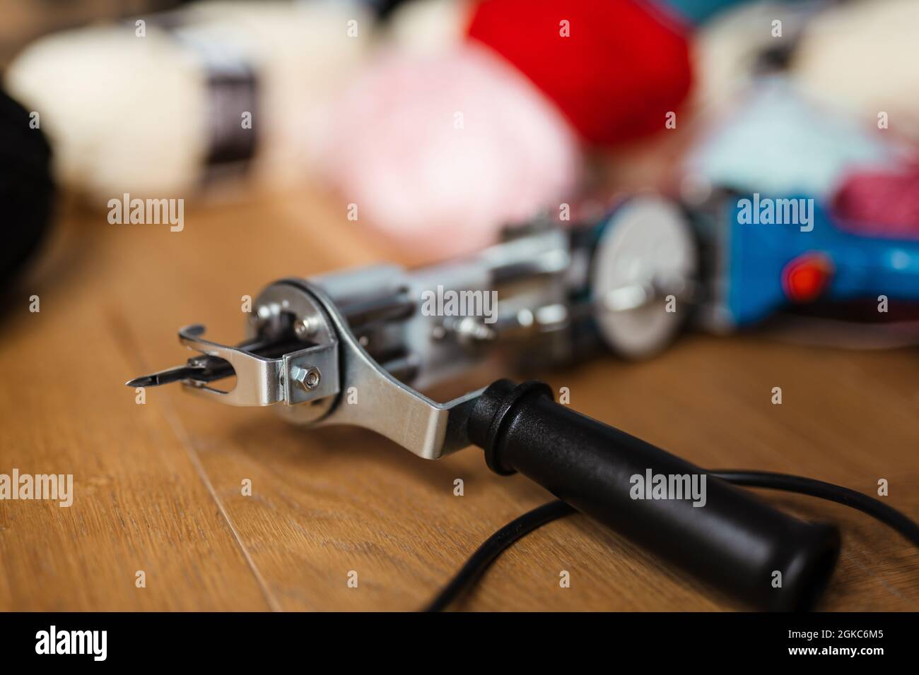 Photo of sewing machine and threads on wooden floor Stock Photo - Alamy