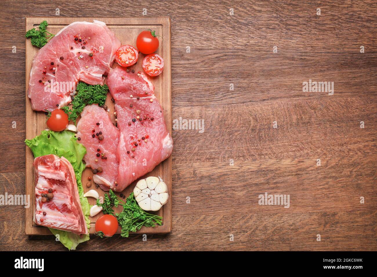 Wooden board with different types of meat on table Stock Photo - Alamy
