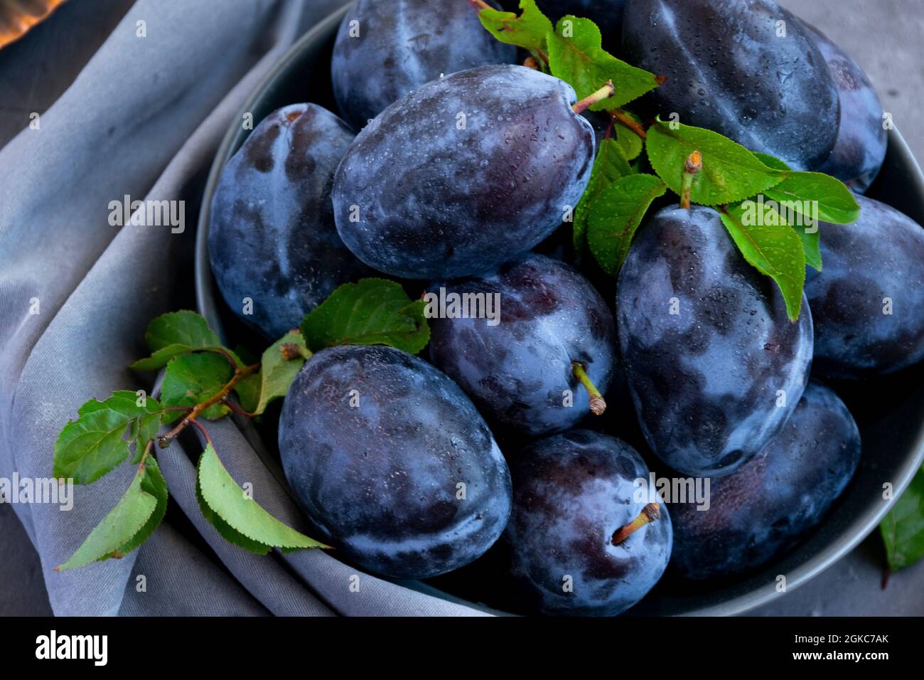 Fresh raw blue plums on the table, monochromatic color image Stock ...