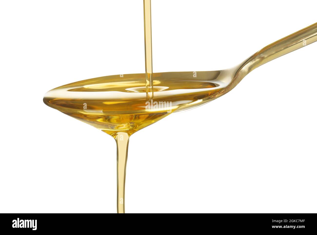 Pouring cooking oil into spoon on white background Stock Photo - Alamy