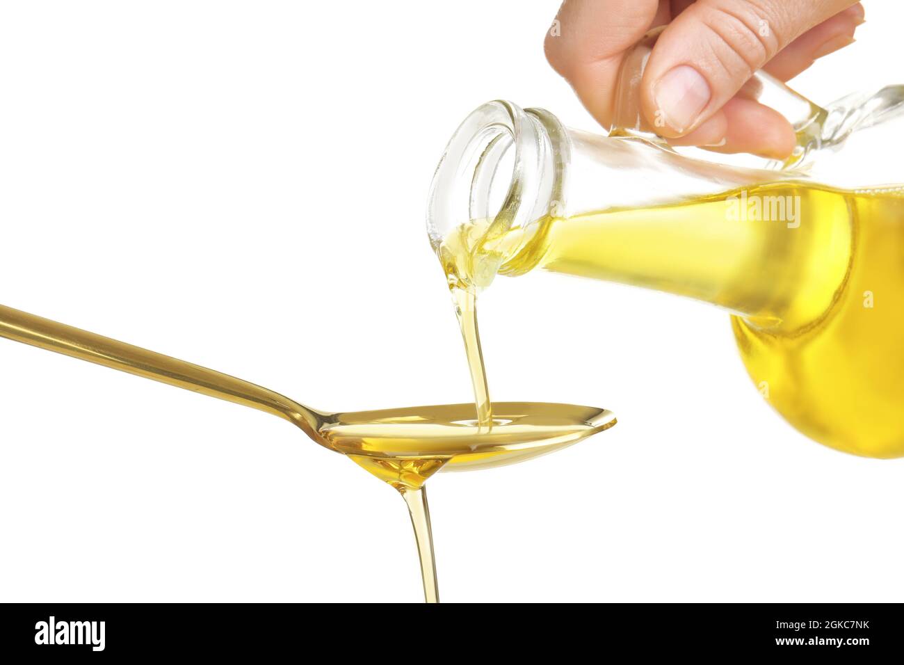 Pouring cooking oil into spoon on white background Stock Photo - Alamy