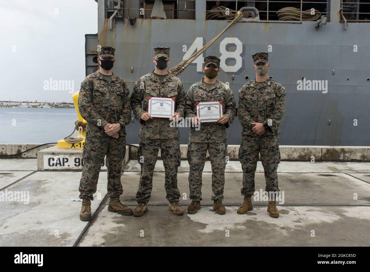 U.S. Marine Cpl. Rory Wade, center left, an infantry Marine and a ...