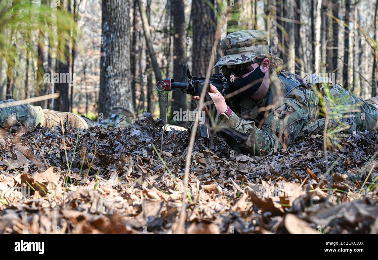 A U.S. Army Soldier scans her sector of fire while her battle buddies ...