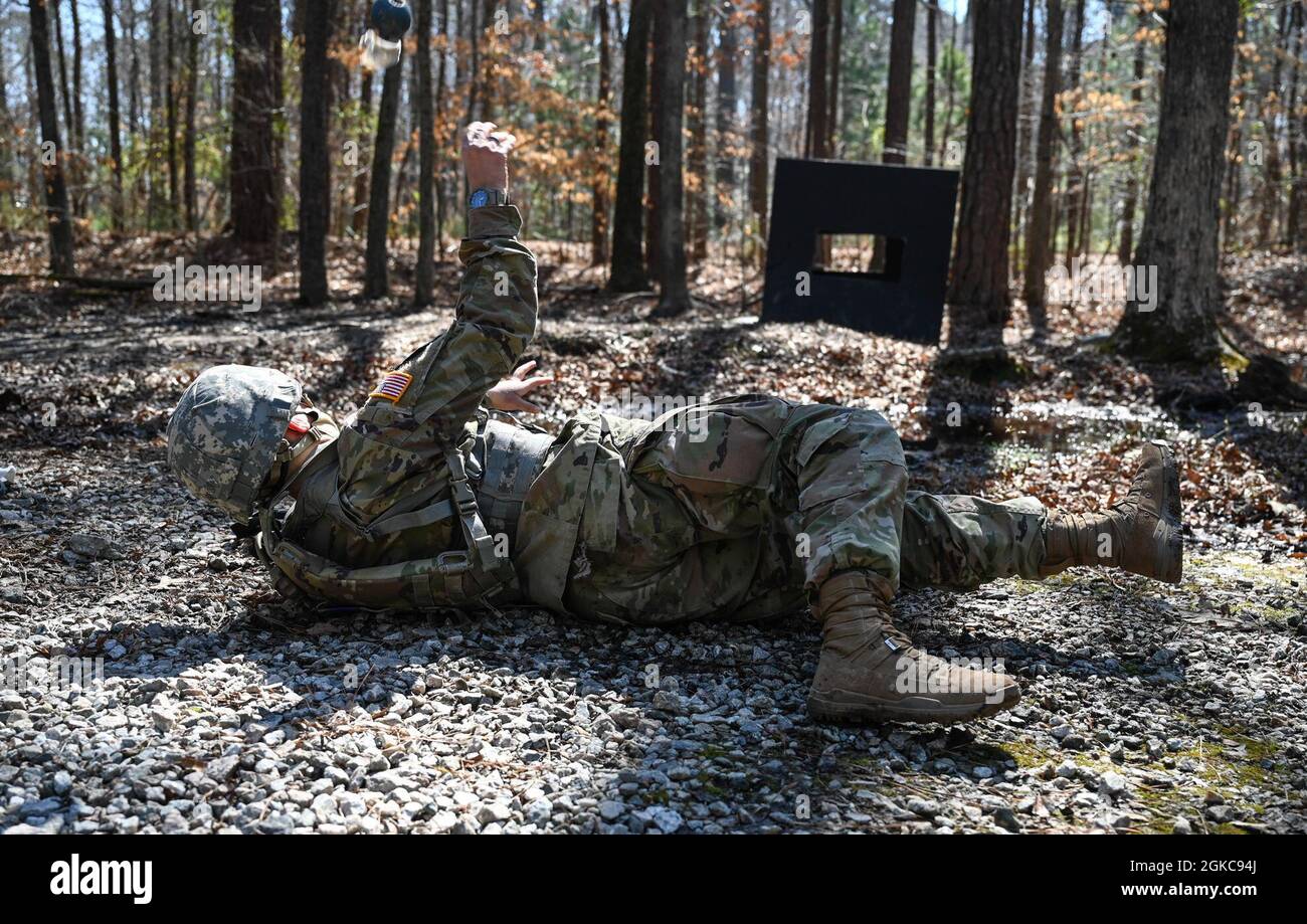 A U.S. Army Soldier throws a simulated hand grenade at a target during ...