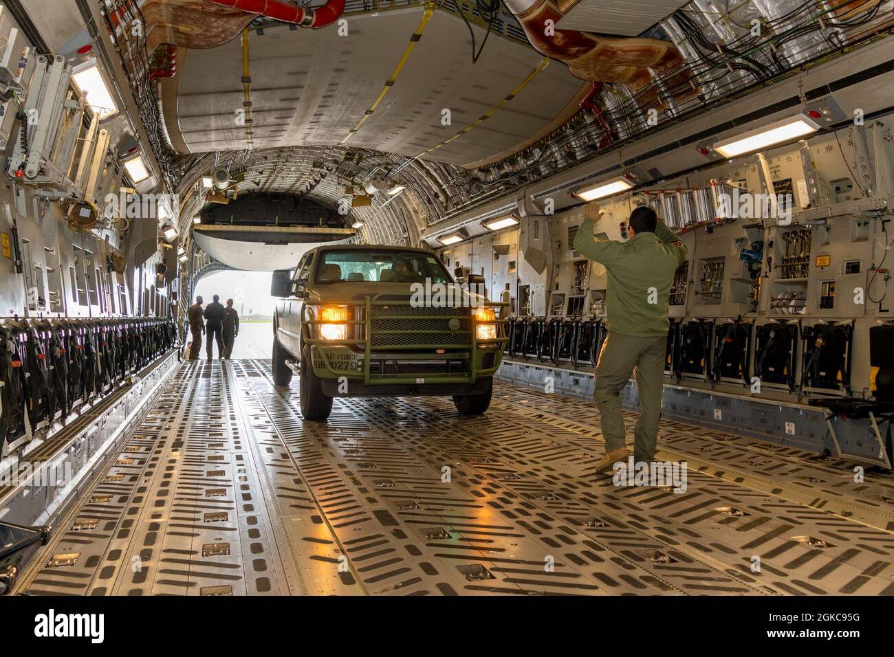 Airman 1st Class Mario Campos, 21st Airlift Squadron loadmaster, guides ...