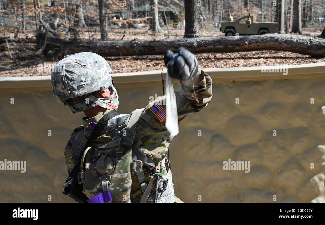 A U.S. Army Soldier throws a simulated hand grenade at a target during ...