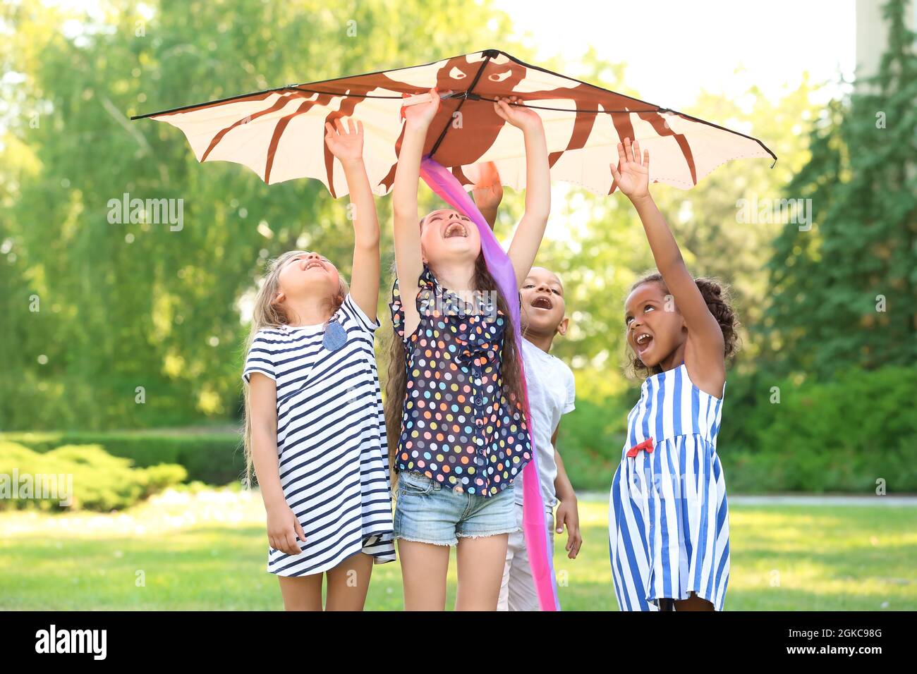 Cute little children playing with kite outdoors Stock Photo - Alamy