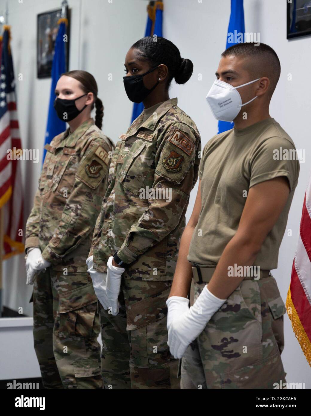 U.S. Air Force Airmen with the base honor guard await the hearse during ...
