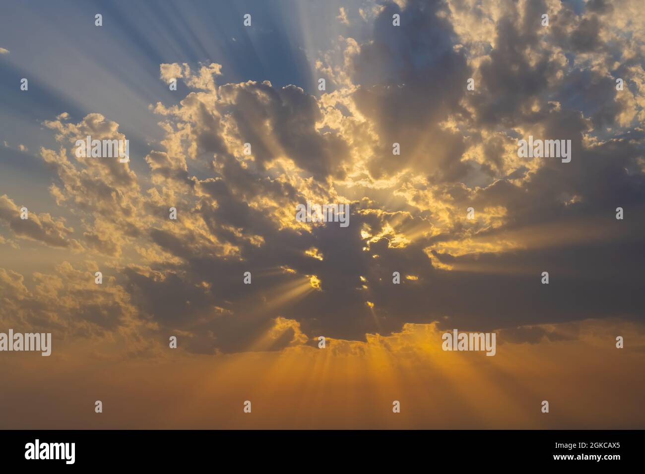 Dramatic sunset sun rays through the clouds Stock Photo - Alamy