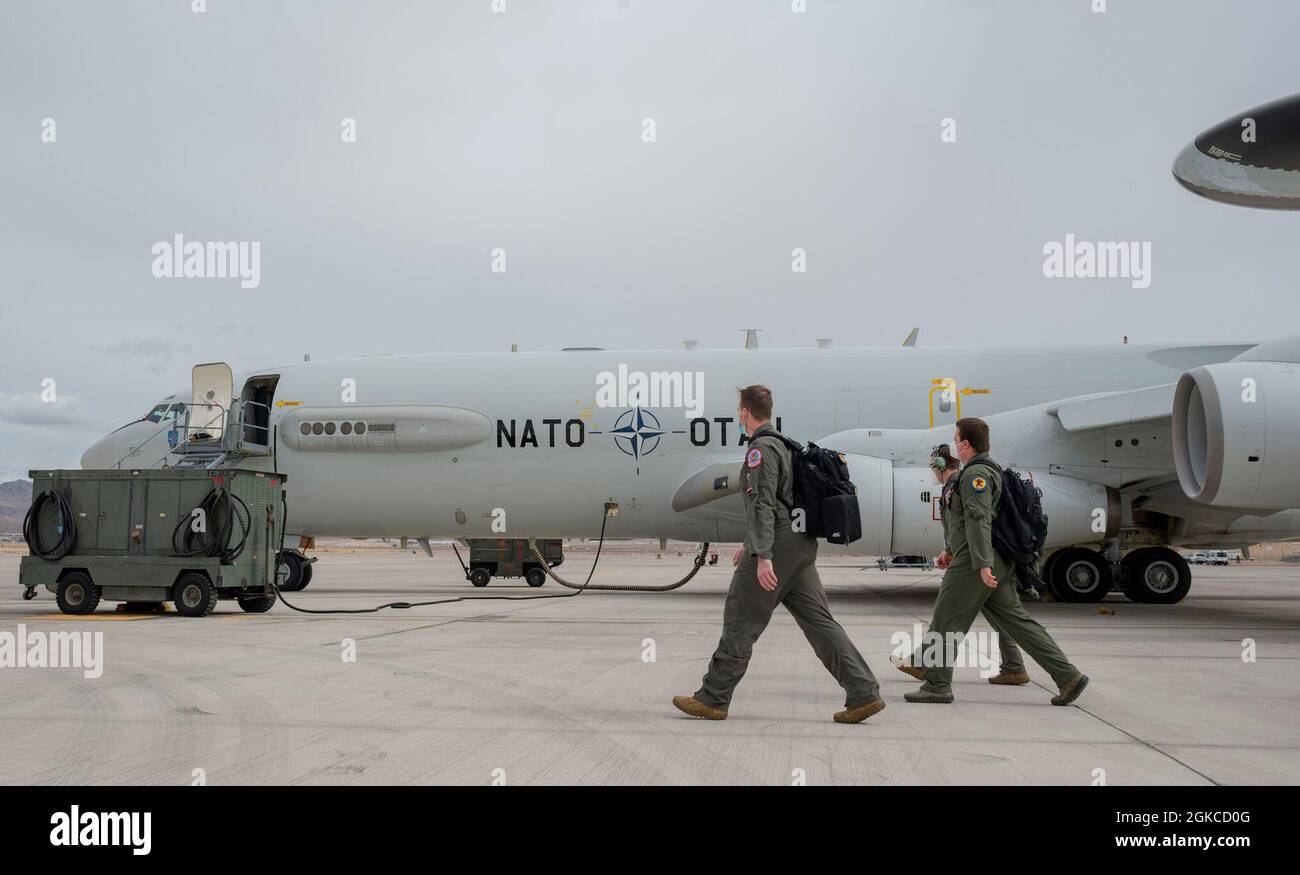 NATO E-3A Airborne Warning and Control System (AWACS) crew members walk ...