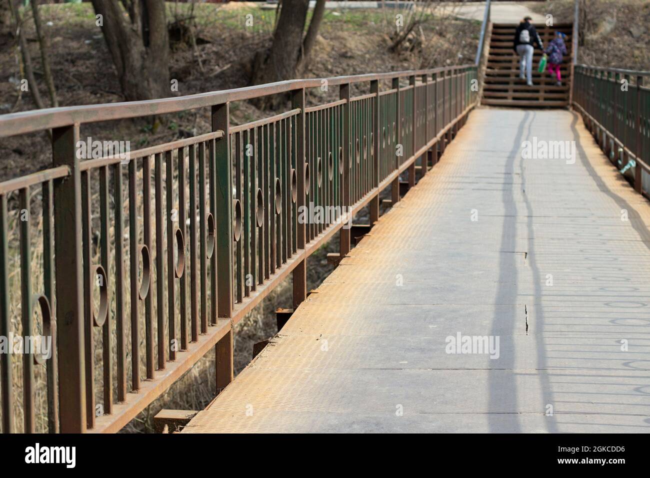 A bridge over the river. A pedestrian bridge over a body of water. It's ...