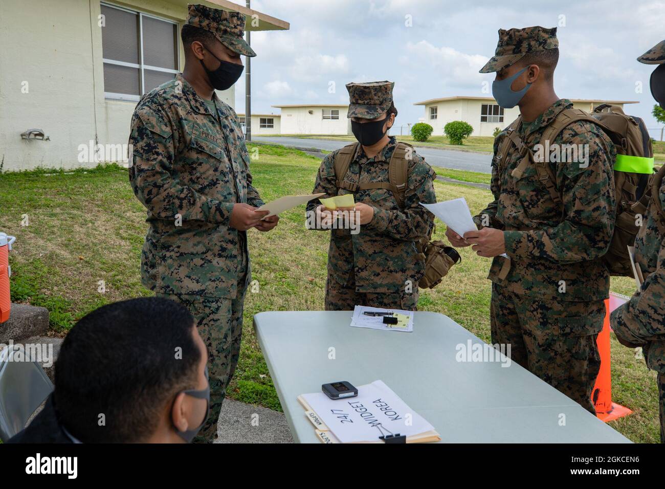 U.S. Marine Corps Lance Cpl. Jennifer Galicia, center, an authorizing ...