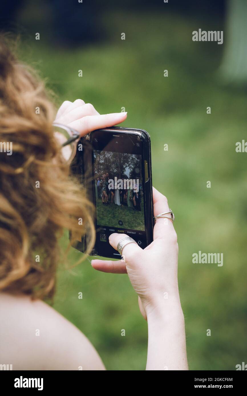the phone screen of a woman taking a photo with her mobile phone or ...