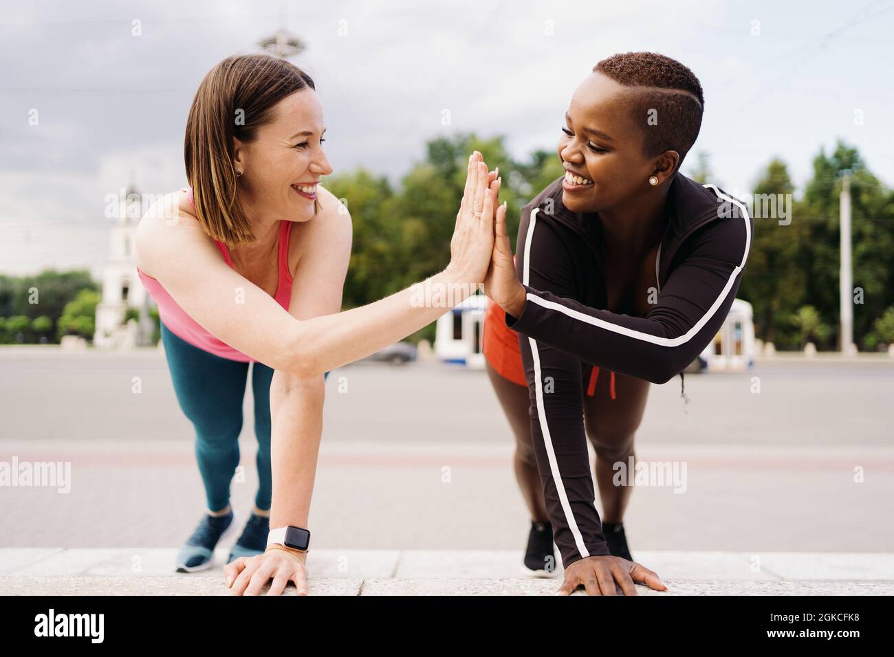 Two smiling diverse young woman in Athletic Workout Clothes are Doing a ...